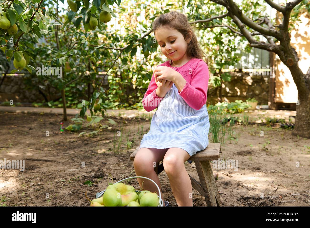Adorable Caucasian little child girl, wearing a stylish blue dress and ...