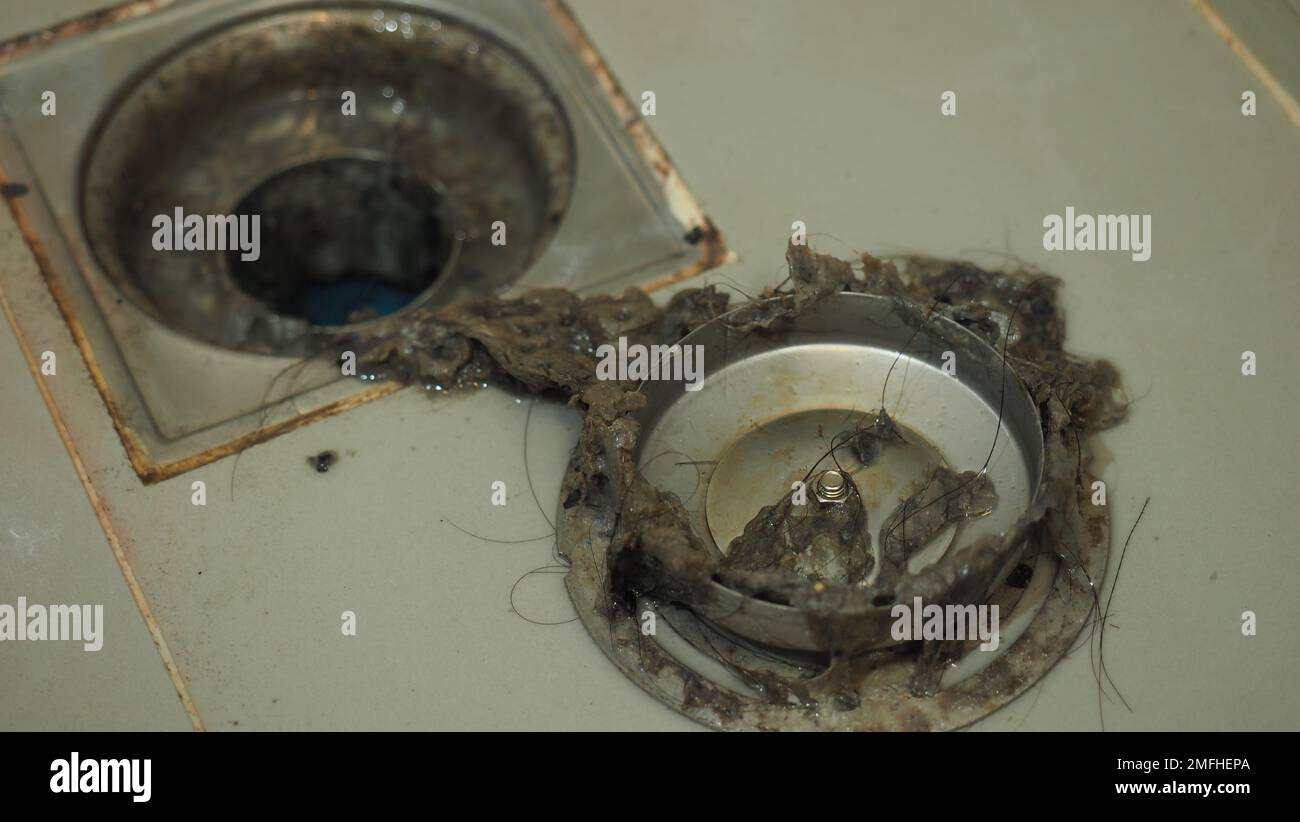 Drain cleaning. Clogged and dirty sewer pipes floor drain. Full of hair ...