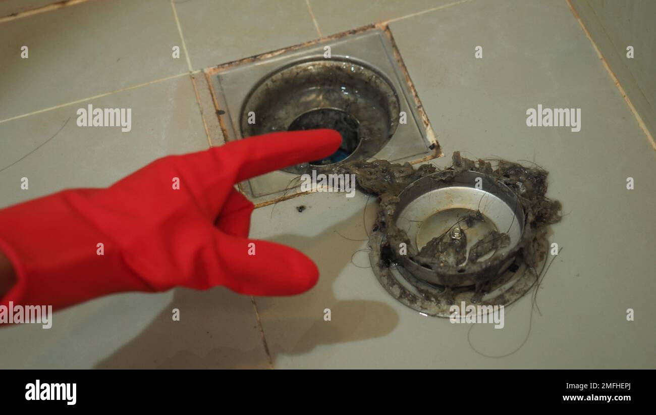 Drain cleaning. Clogged and dirty sewer pipes floor drain. Full of hair ...