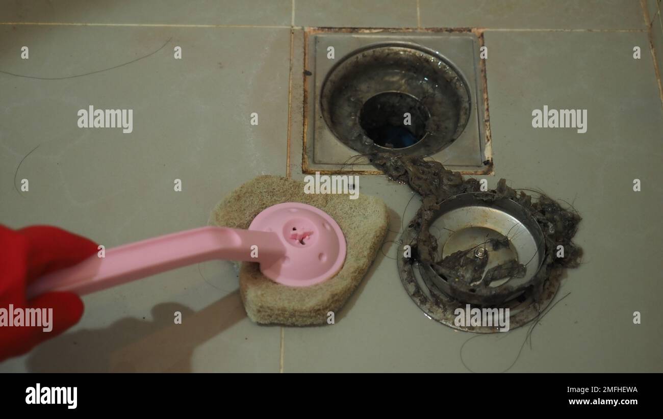 Drain cleaning. Clogged and dirty sewer pipes floor drain. Full of hair ...