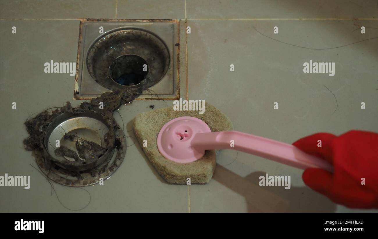 Drain cleaning. Clogged and dirty sewer pipes floor drain. Full of hair ...