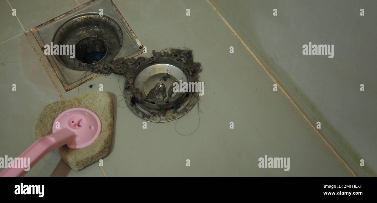 Drain cleaning. Clogged and dirty sewer pipes floor drain. Full of hair ...