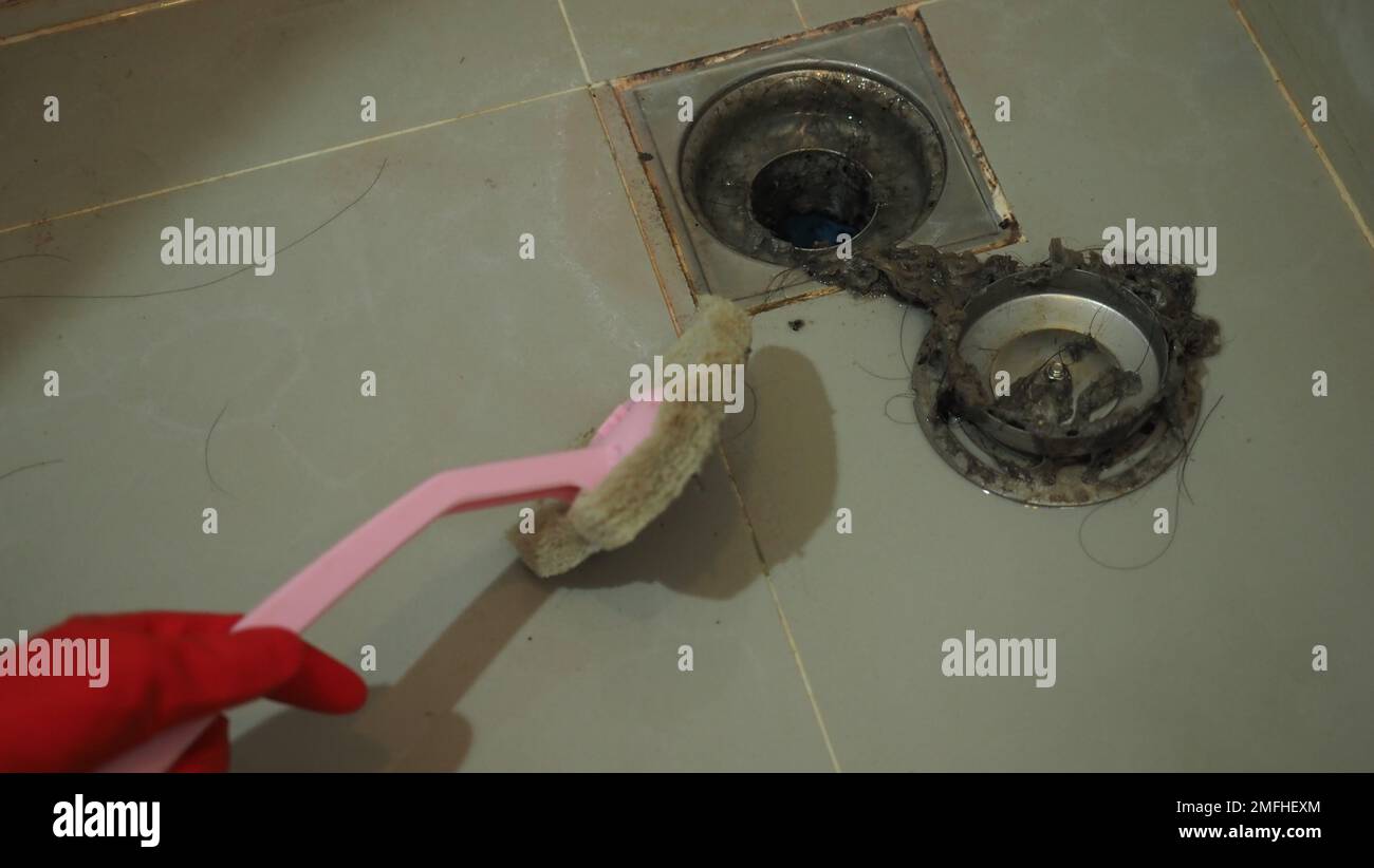 Drain cleaning. Clogged and dirty sewer pipes floor drain. Full of hair ...