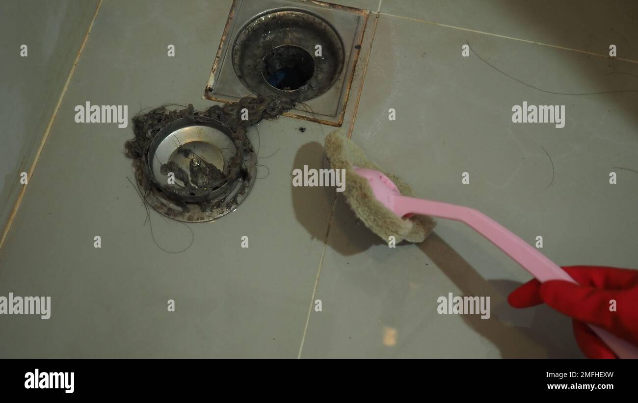 Drain cleaning. Clogged and dirty sewer pipes floor drain. Full of hair ...