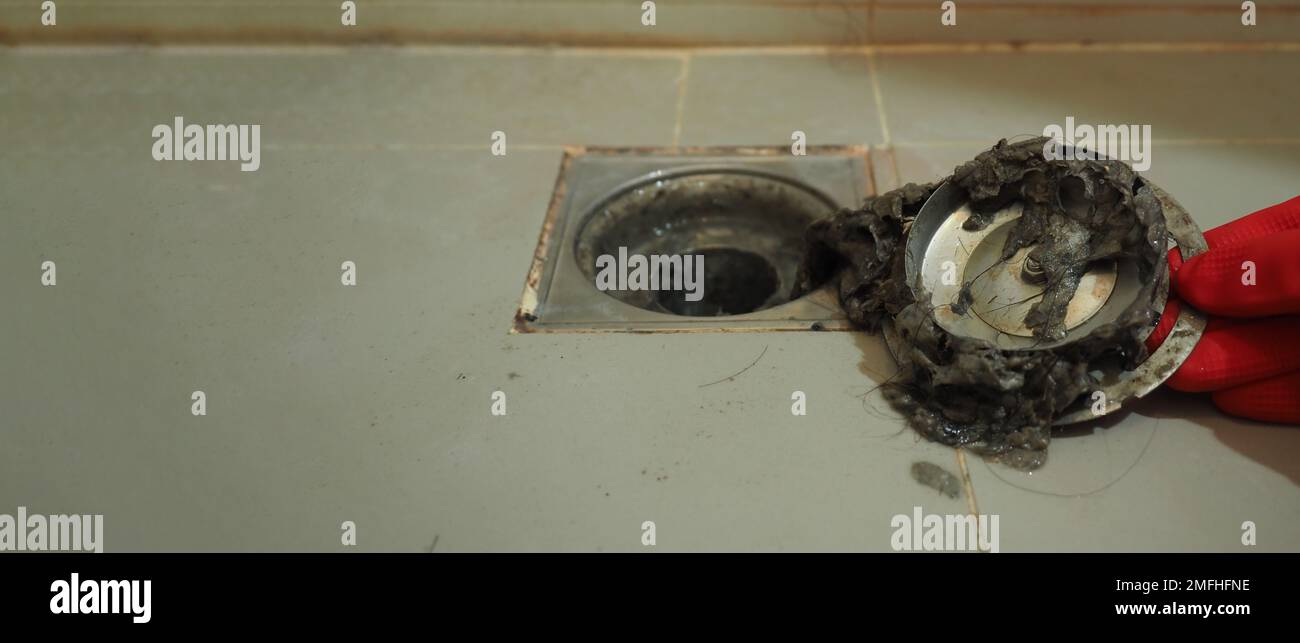 Drain cleaning. Clogged and dirty sewer pipes floor drain. Full of hair ...