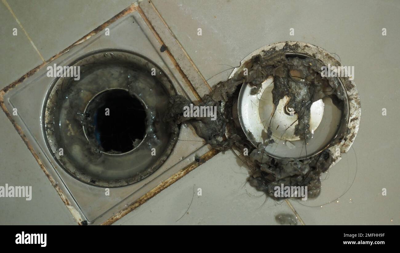 Drain cleaning. Clogged and dirty sewer pipes floor drain. Full of hair ...