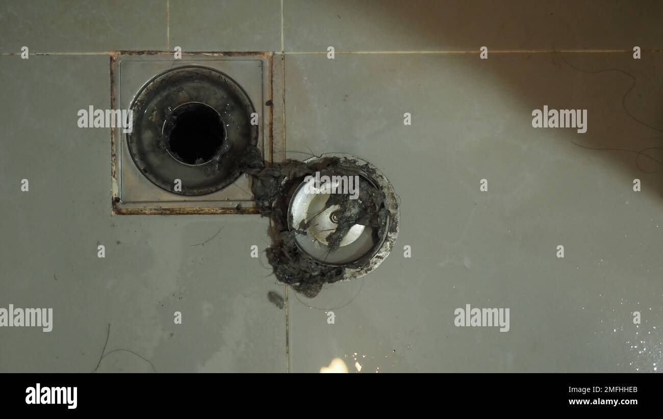 Drain cleaning. Clogged and dirty sewer pipes floor drain. Full of hair ...