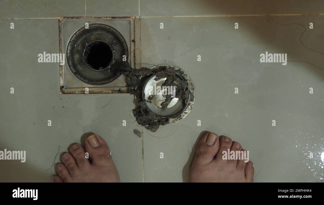 Drain cleaning. Clogged and dirty sewer pipes floor drain. Full of hair ...