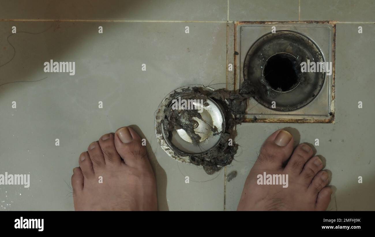 Drain cleaning. Clogged and dirty sewer pipes floor drain. Full of hair ...