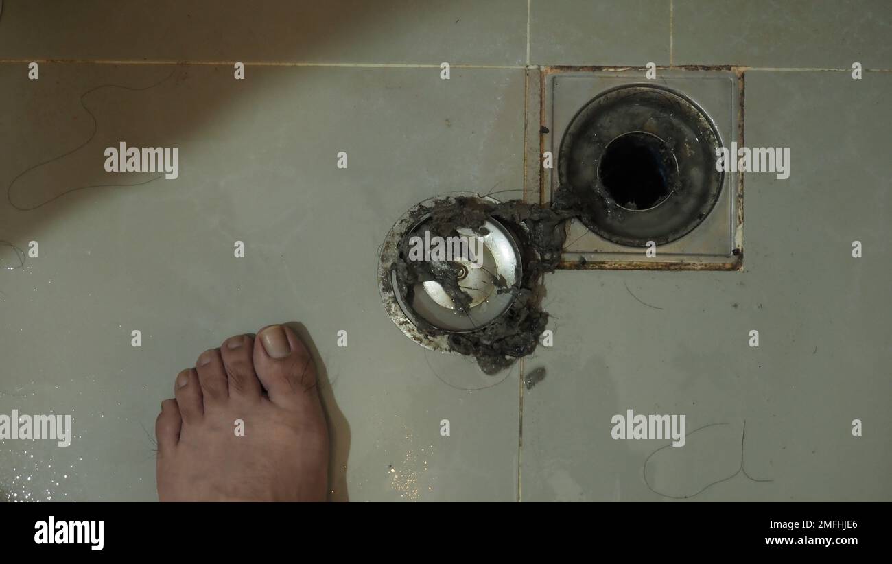 Drain cleaning. Clogged and dirty sewer pipes floor drain. Full of hair ...