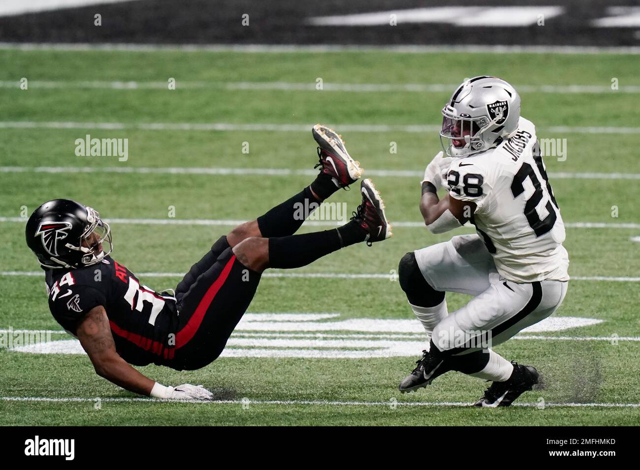 Las Vegas Raiders running back Josh Jacobs (28) hits Atlanta Falcons ...