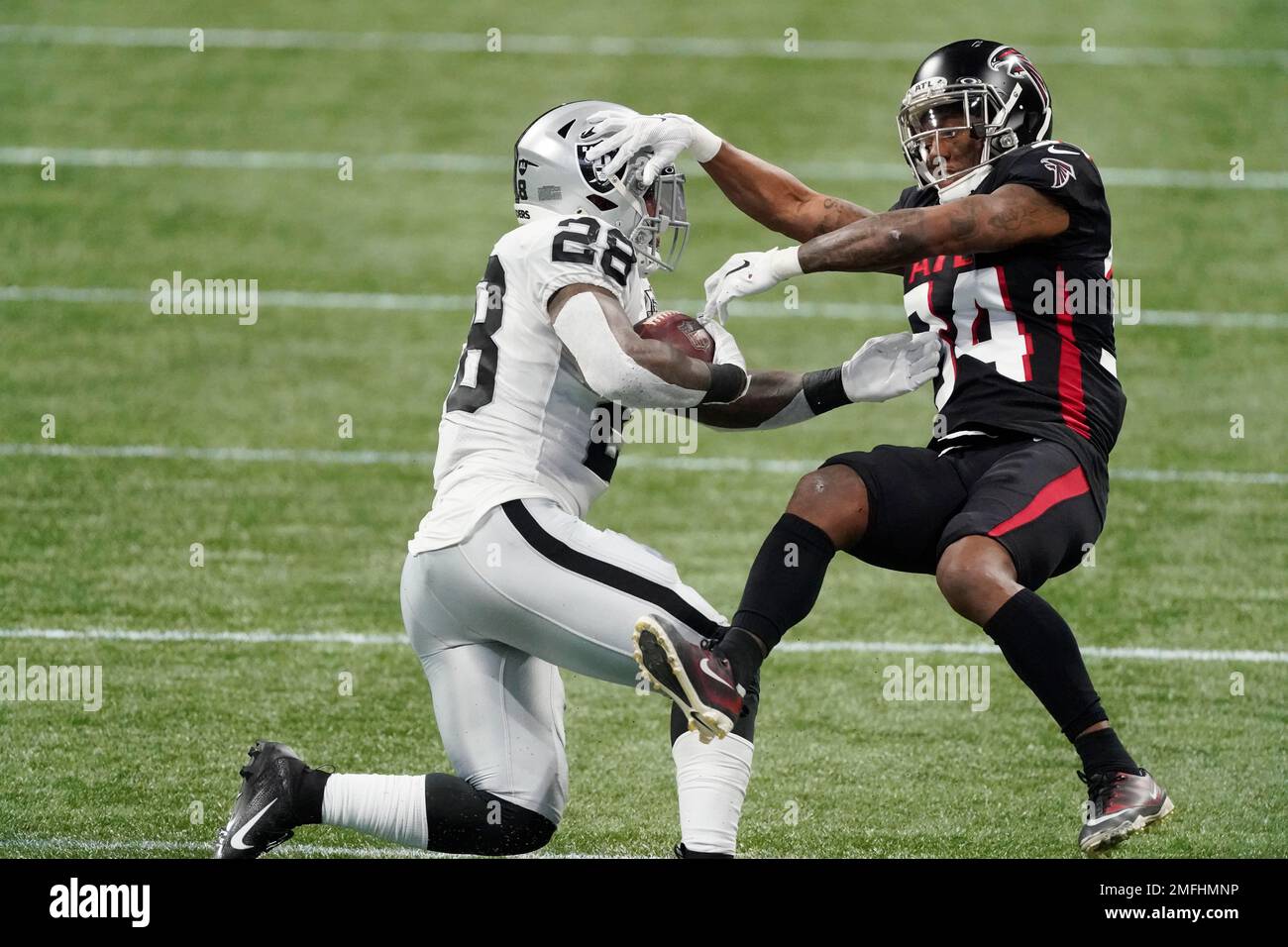 Las Vegas Raiders running back Josh Jacobs (28) hits Atlanta Falcons ...