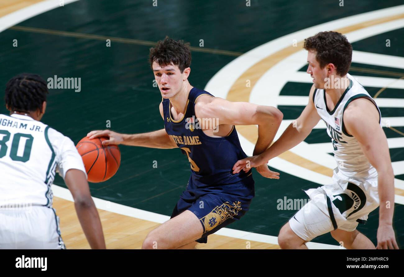 Notre Dame's Cormac Ryan, center, drives against Michigan State's ...