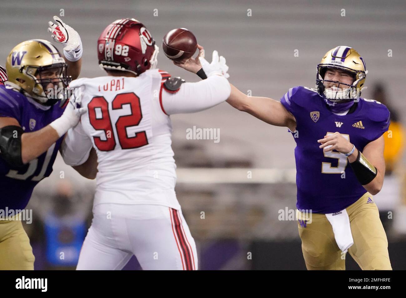 Washington quarterback Dylan Morris, right, passes under pressure from ...