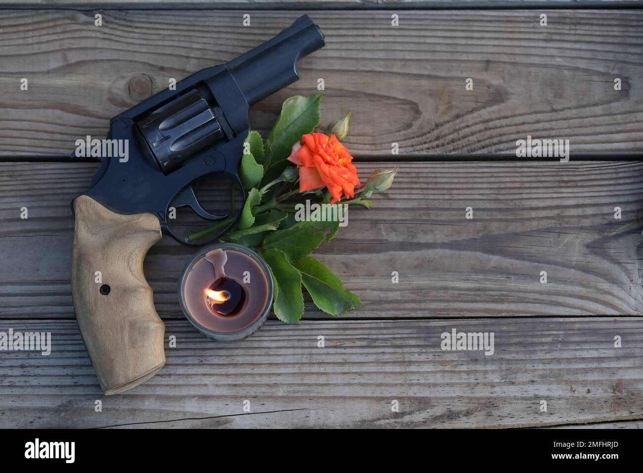 art photo. vintage still life with gun and rose on wooden background ...