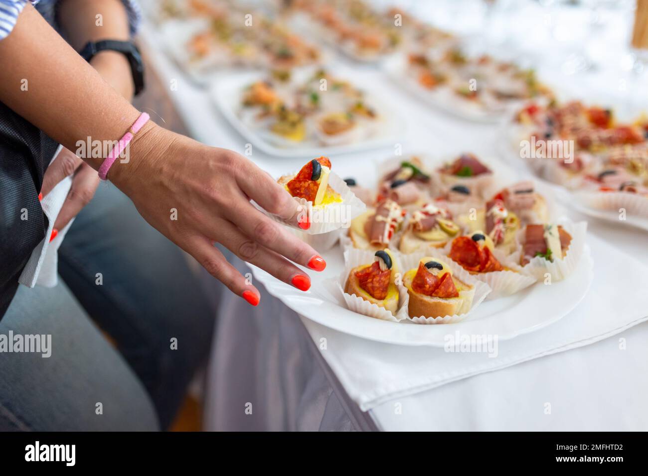Woman hand picking up canape from table on celebration event Stock ...