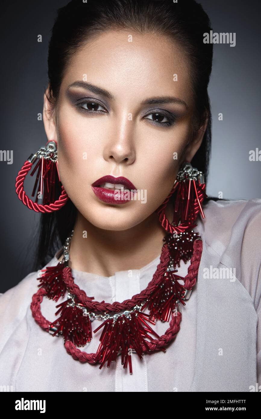 Beautiful fashionable girl with smooth hair and original decoration ...