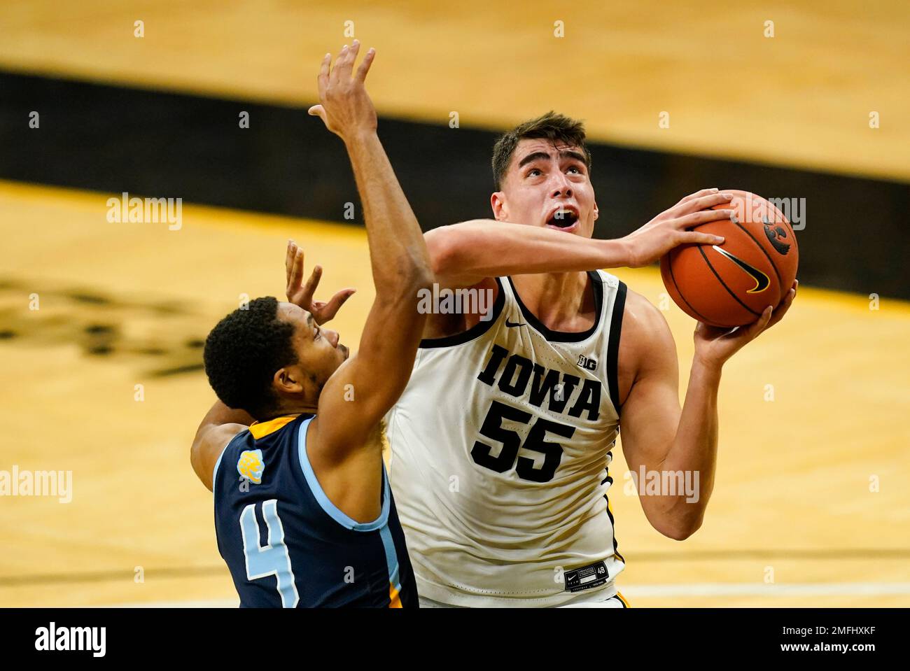 Iowa center Luka Garza (55) drives to the basket ahead of Southern ...
