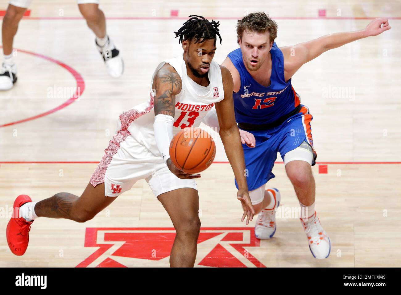 Houston forward J'Wan Roberts (13) scoops up a loose ball in front of ...