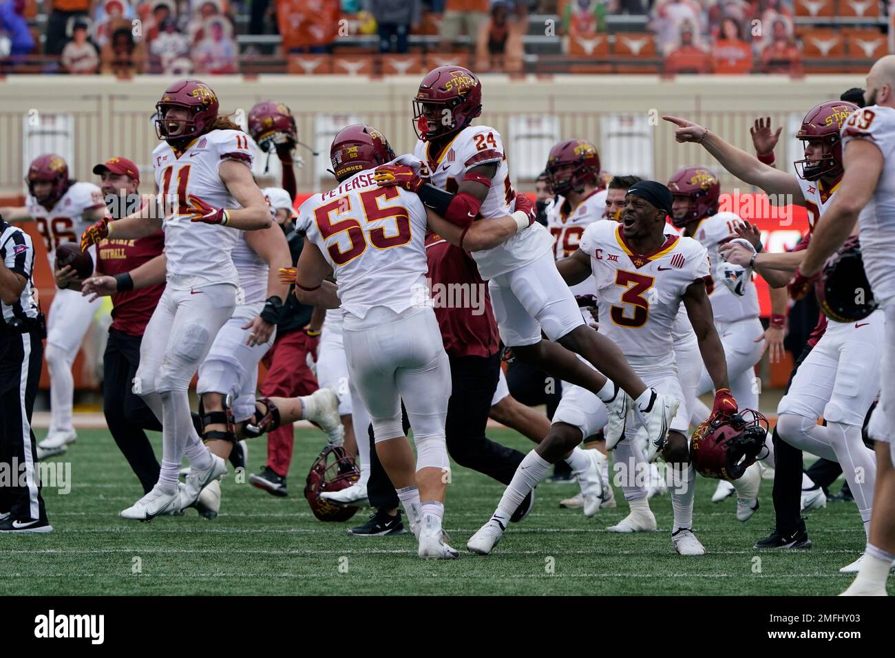 Iowa State players and coaches storm the field as they celebrate their ...