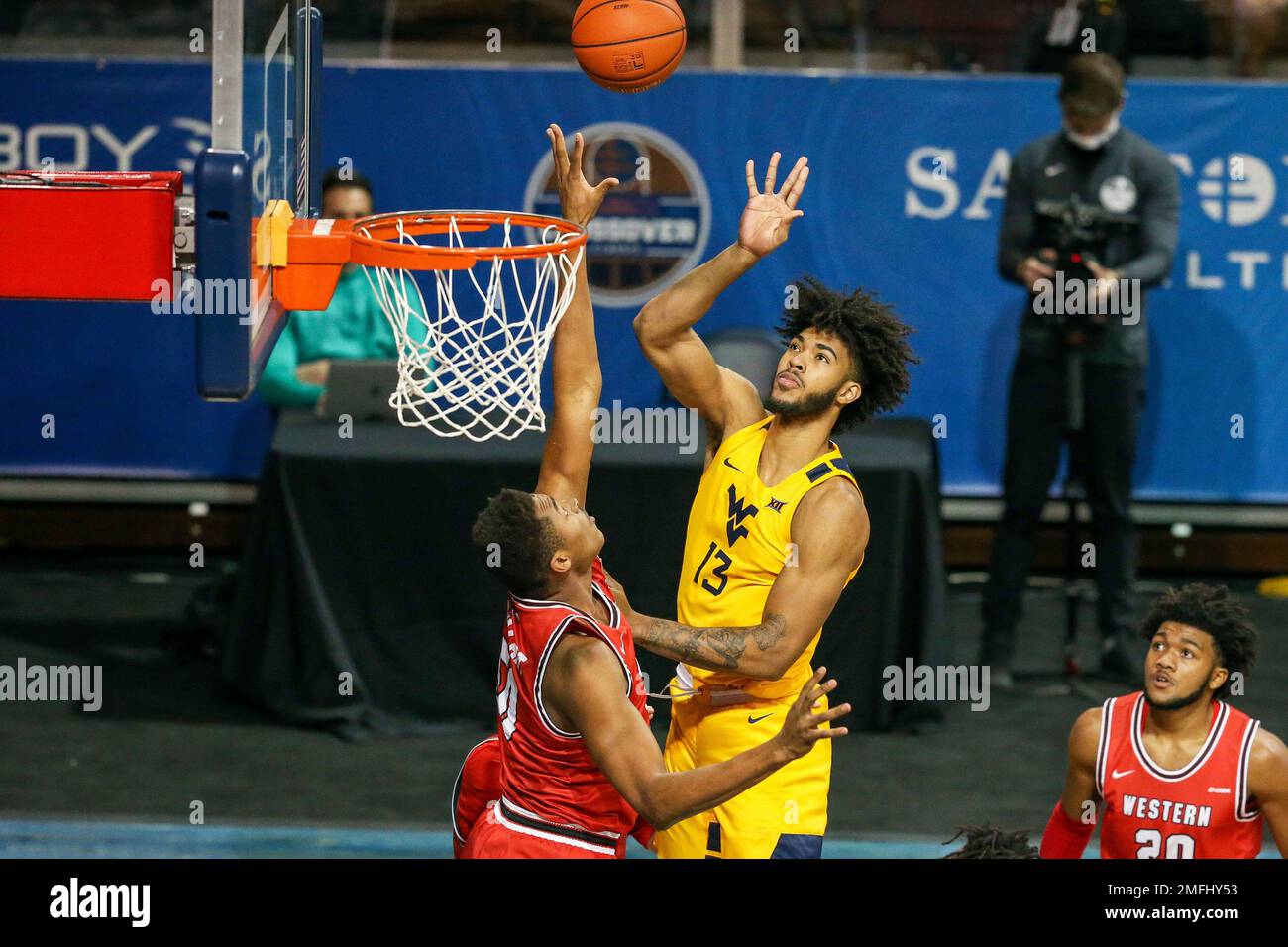 West Virginia forward Isaiah Cottrell (13) floats the ball to the hoop ...