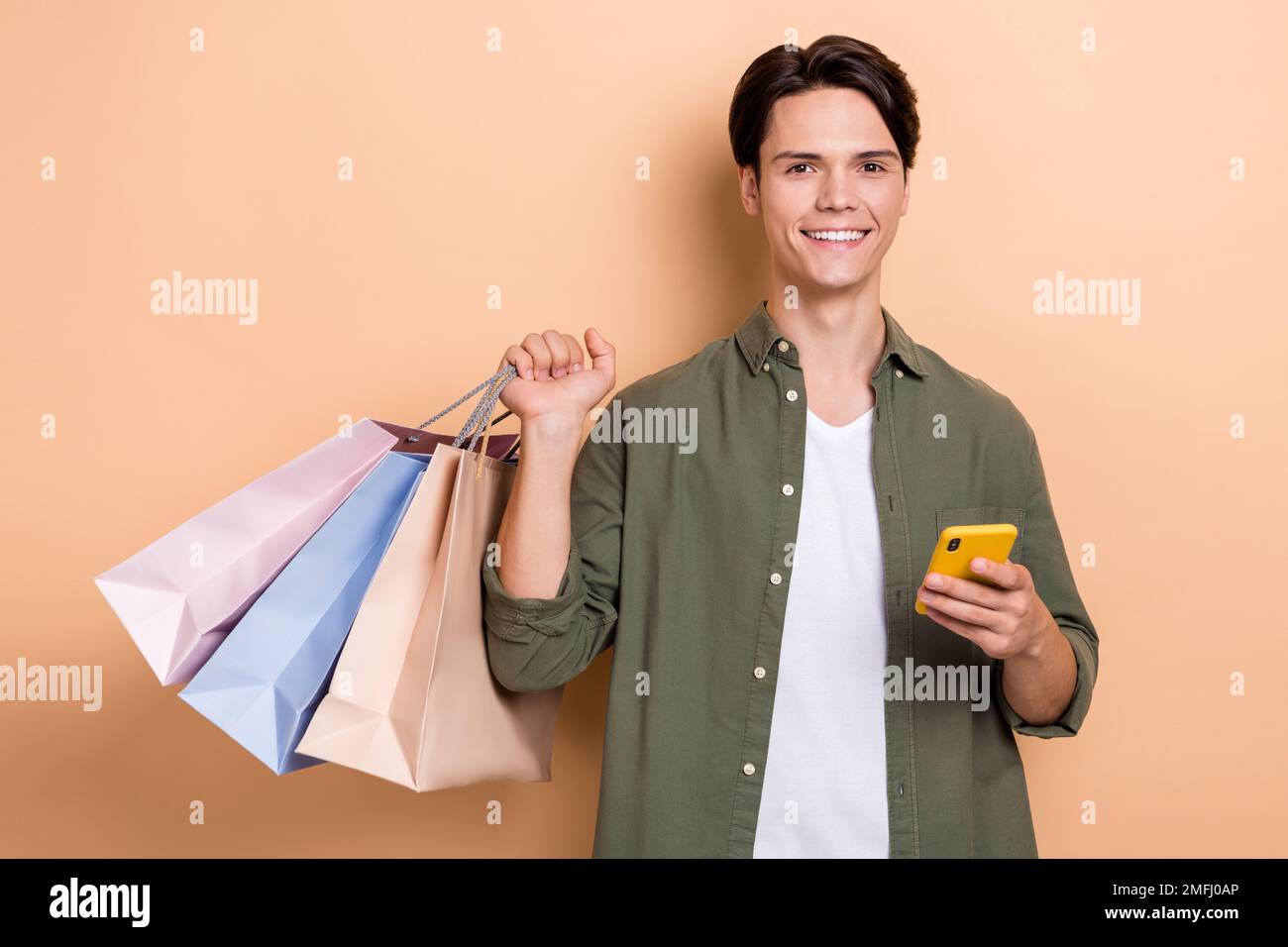 Photo of shopaholic guy student handsome person wearing stylish khaki ...
