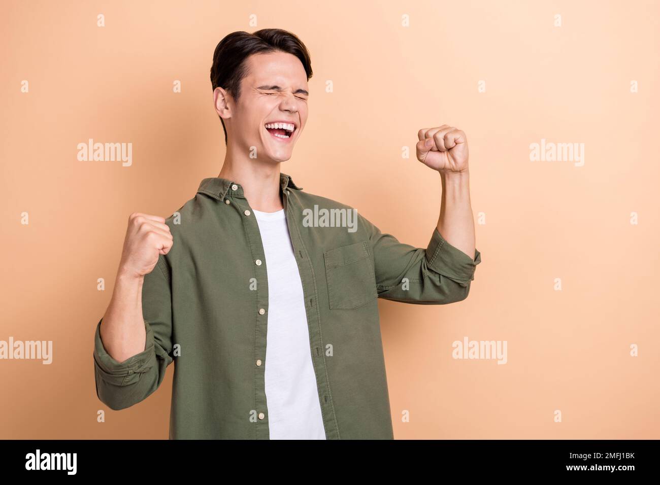 Portrait of astonished satisfied person closed eyes raise fists scream ...