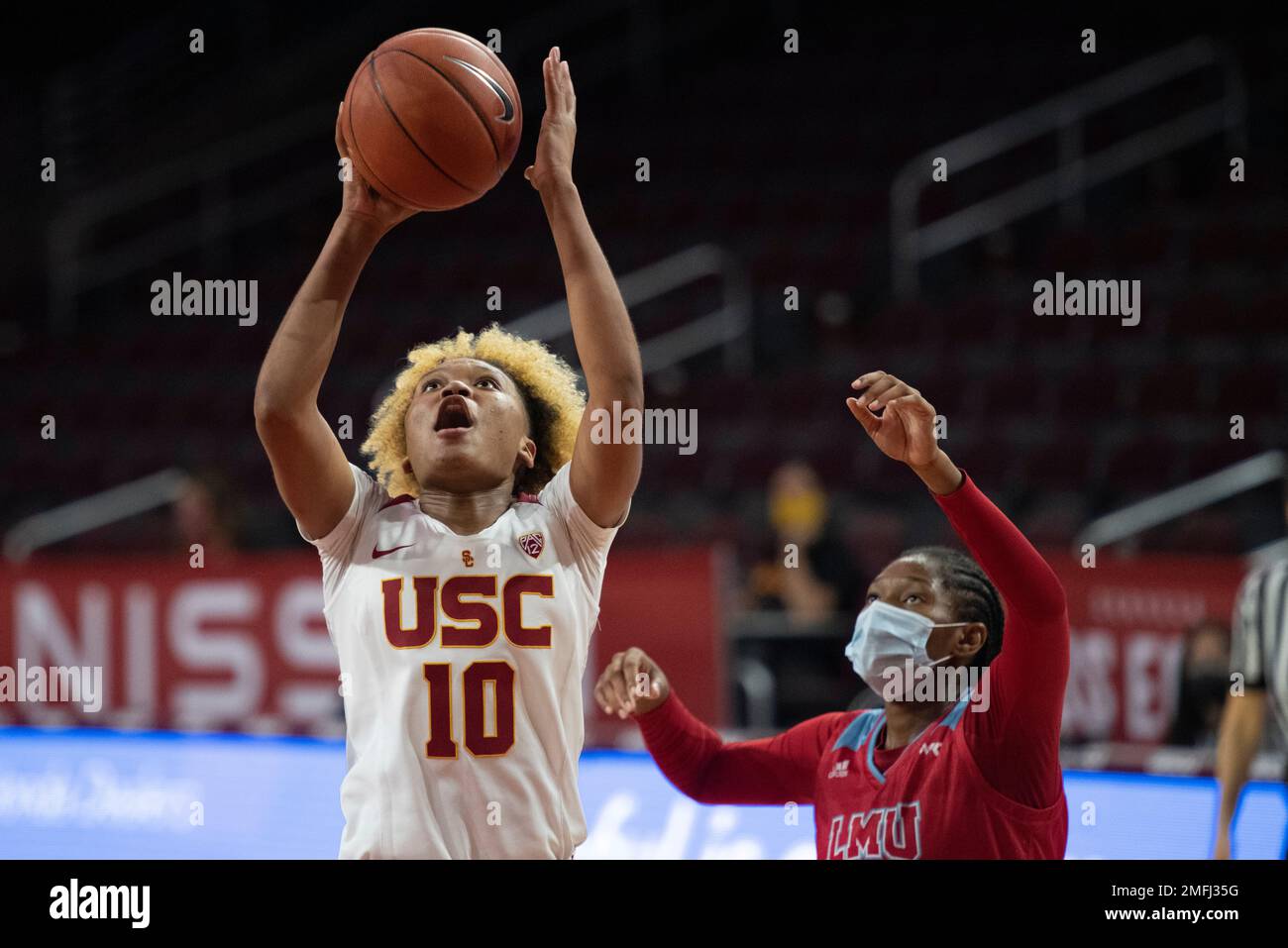Southern California guard Amaya Oliver, left, shoots past Loyola ...