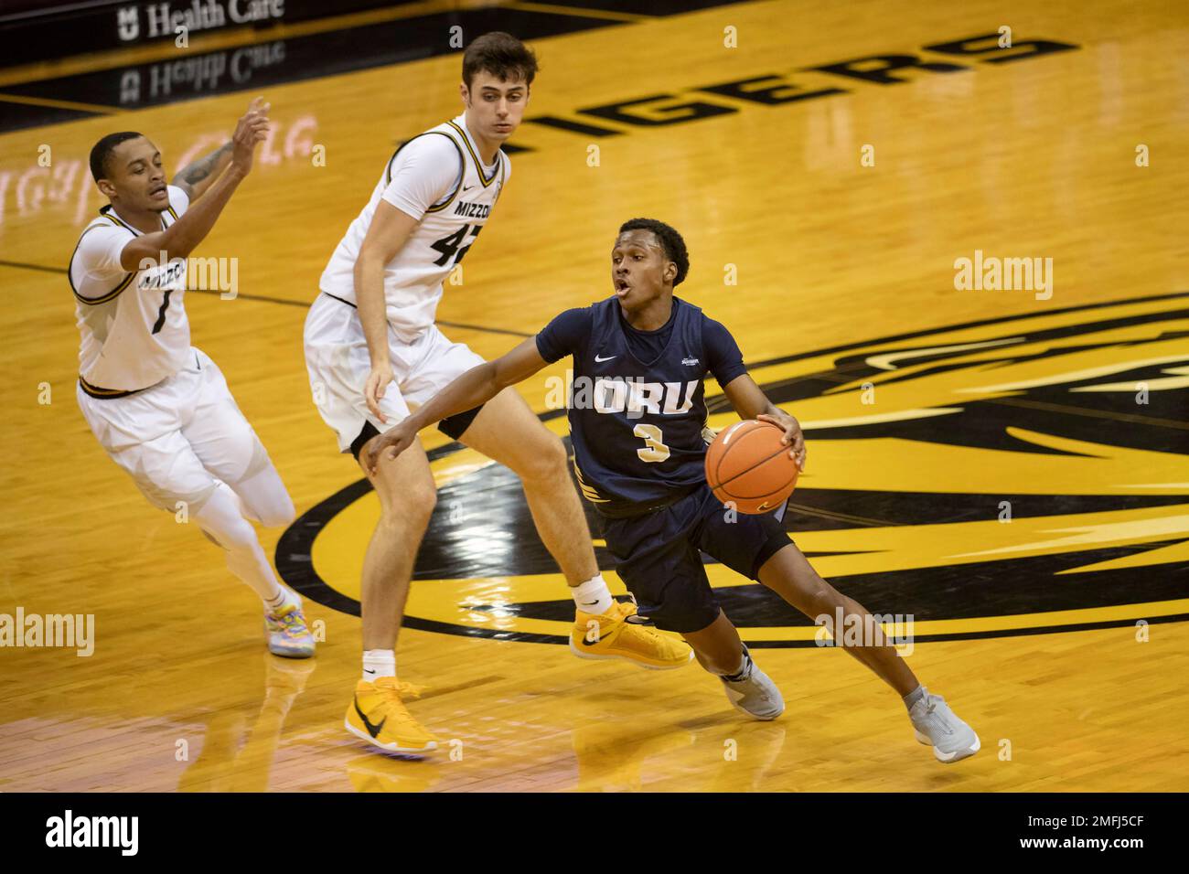 Oral Roberts' Max Abmas, right, dribbles around Missouri's Parker Braun ...