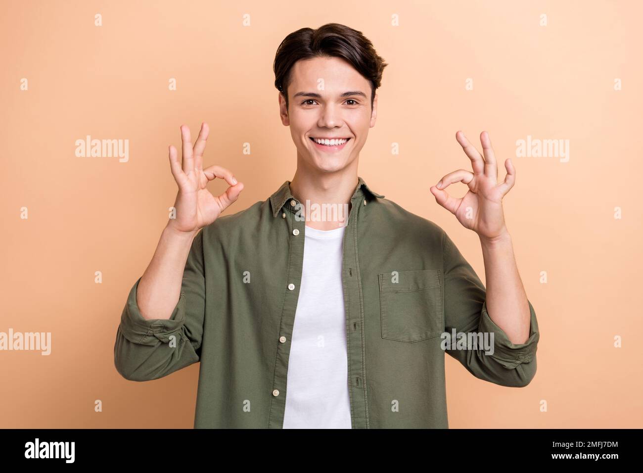 Portrait of satisfied glad man toothy smile hands fingers show okey ...