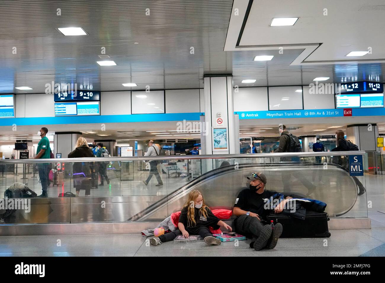 Travelers wait to board their train in Penn Stations main concourse ...