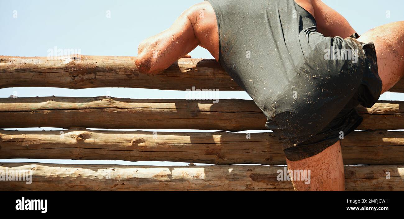 Mud race runners participant overcome obstacles extreme sport Stock ...