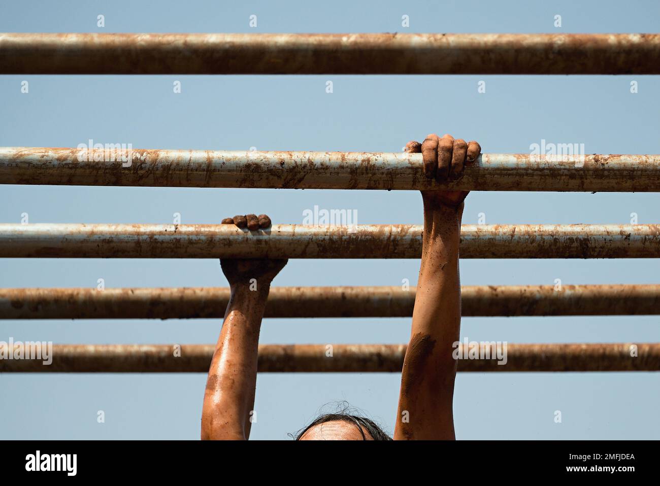 Mud race runners,hands overcome obstacle.Hand over hand Stock Photo - Alamy