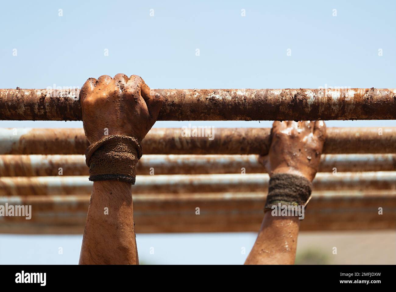 Mud race runners,hands overcome obstacle.Hand over hand Stock Photo - Alamy