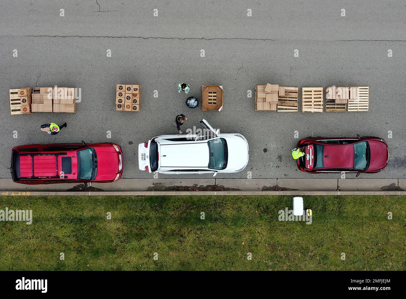 Volunteers load boxes of food into a car during a Greater Pittsburgh ...