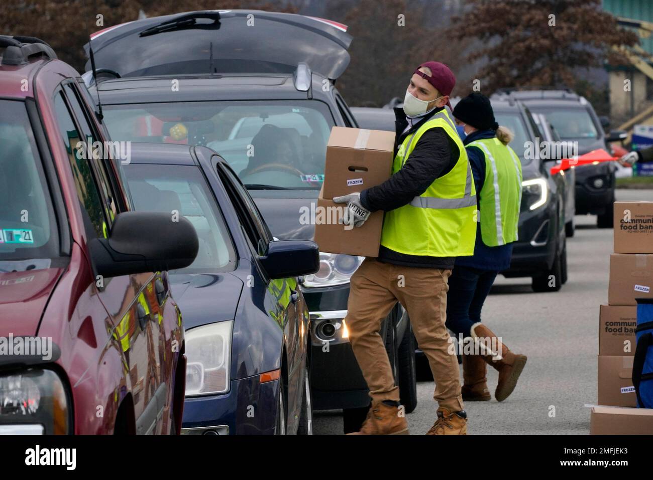 Volunteers load boxes of food into a car during a Greater Pittsburgh ...