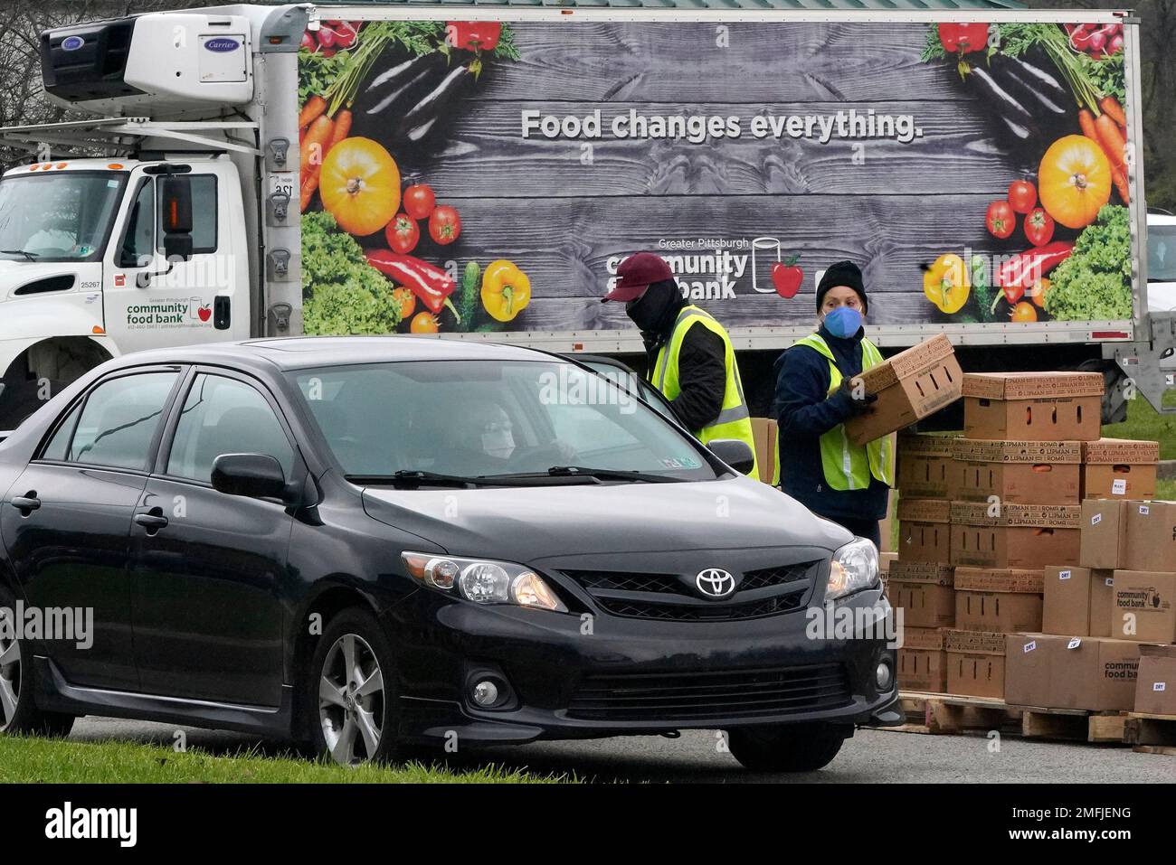 Volunteers load boxes of food into a car during a Greater Pittsburgh ...