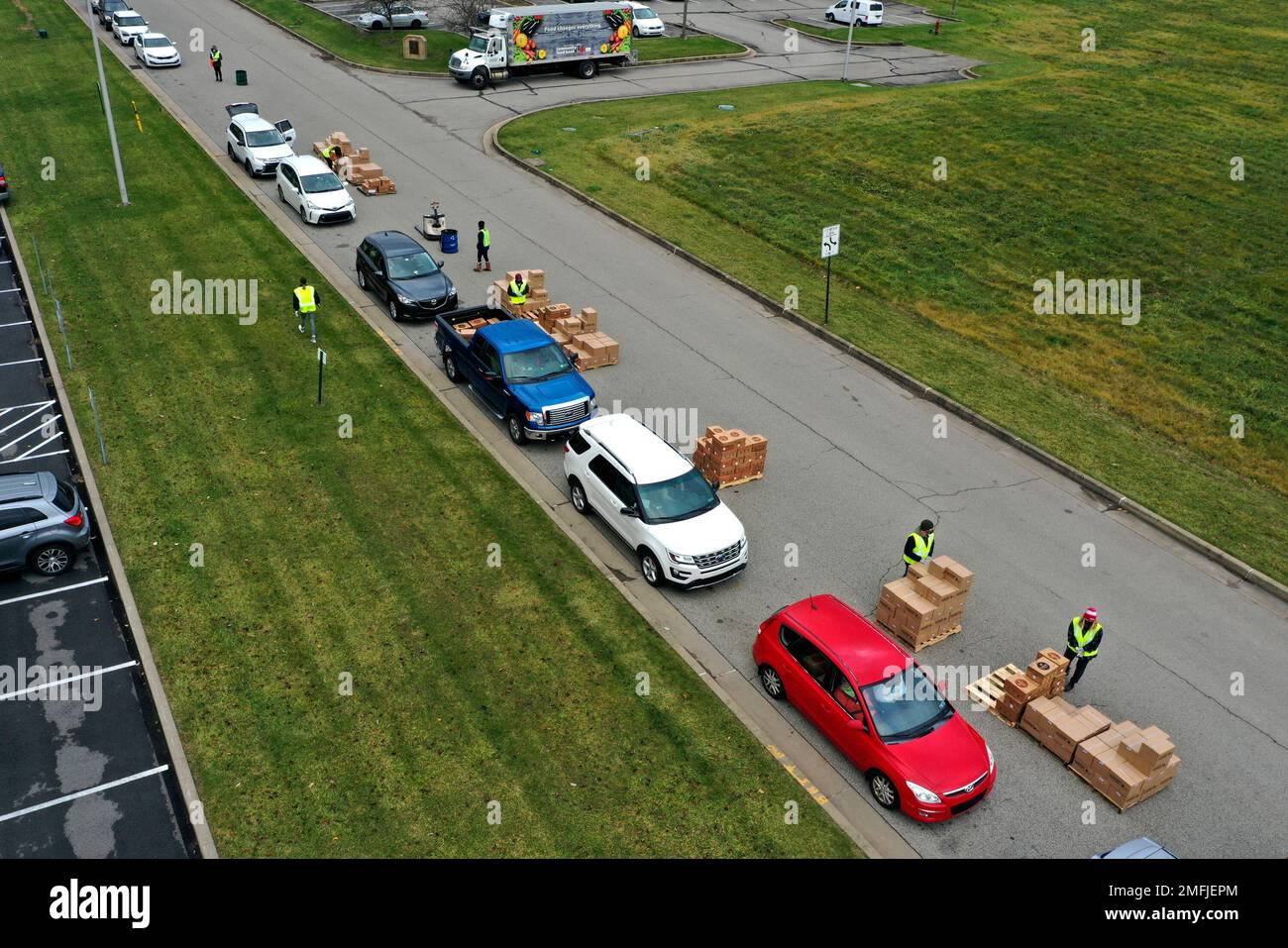 Volunteers load boxes of food into a car during a Greater Pittsburgh ...