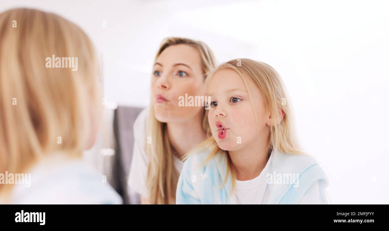 Happy, funny faces and mother with a child looking in the mirror while ...