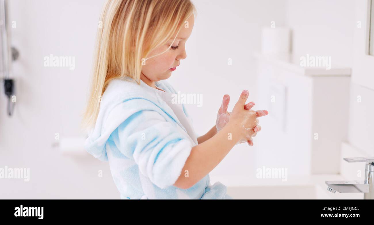 Girl washing her hands in the bathroom of her home for hygiene, stop ...