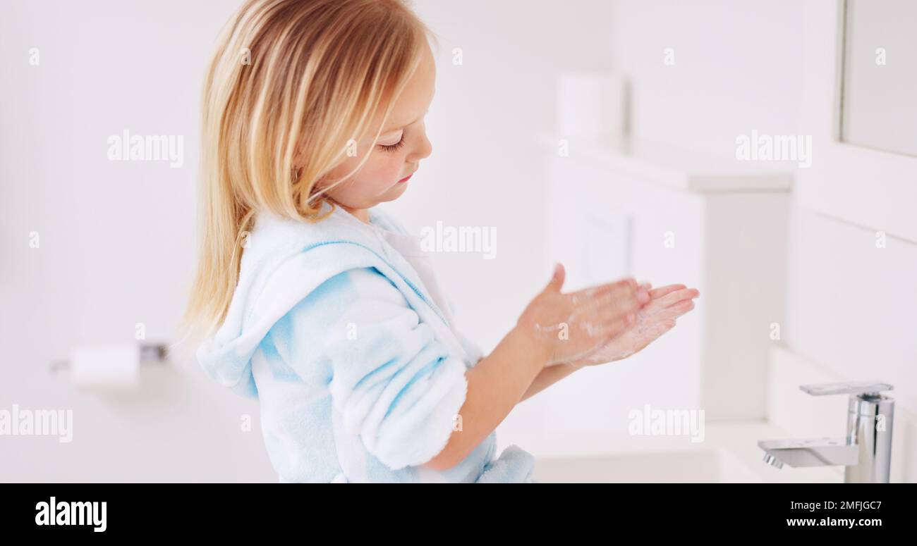 Girl washing her hands in the bathroom of her home for hygiene, stop ...