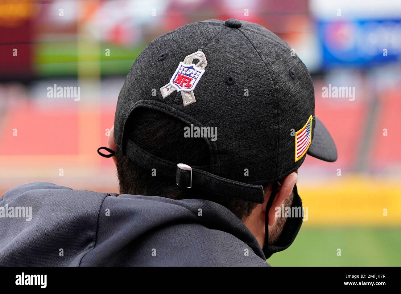 A member of the NFL field crew wearing a ball cap with Salute to ...