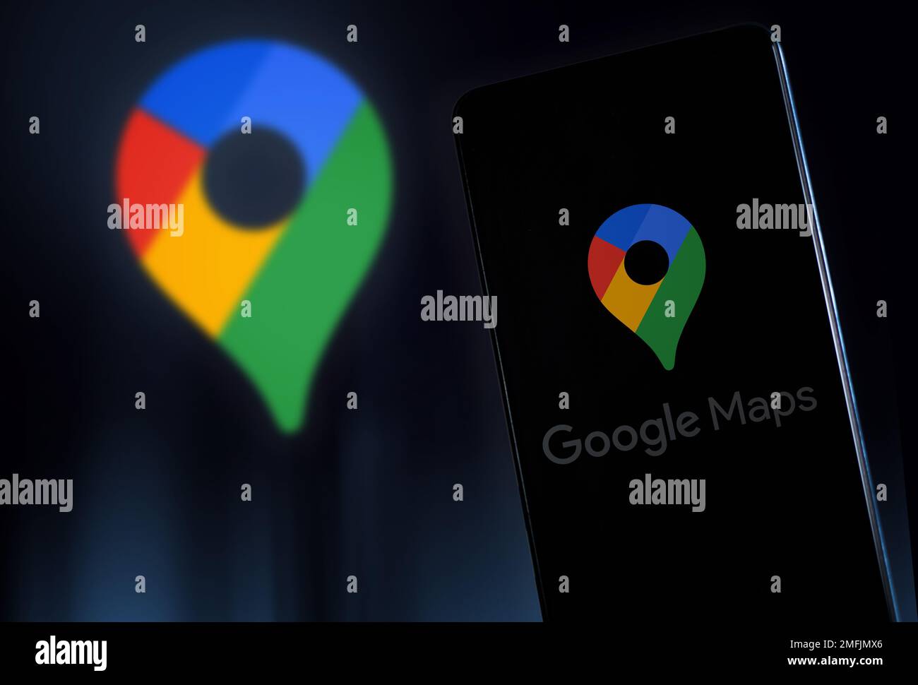 Google Maps logo on smartphone display and background. Milan Italy ...