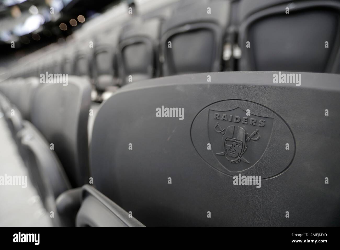 A Raiders badge is seen on a seat before an NFL football game between ...