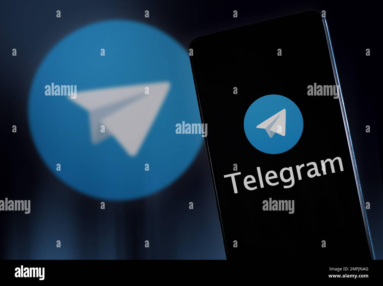 Telegram logo on smartphone display and background. Communication ...
