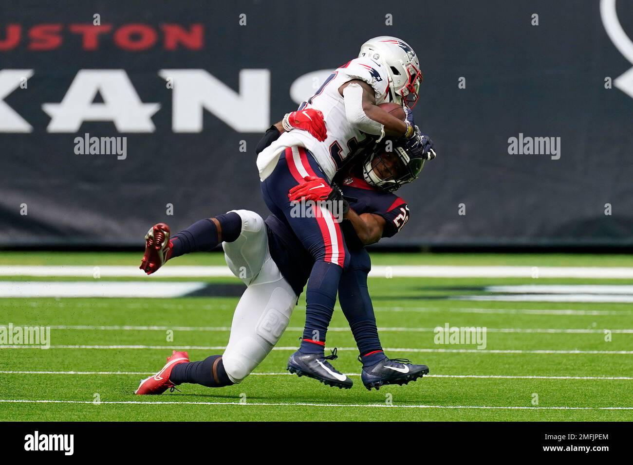 New England Patriots running back Damien Harris (37) is tackled by ...