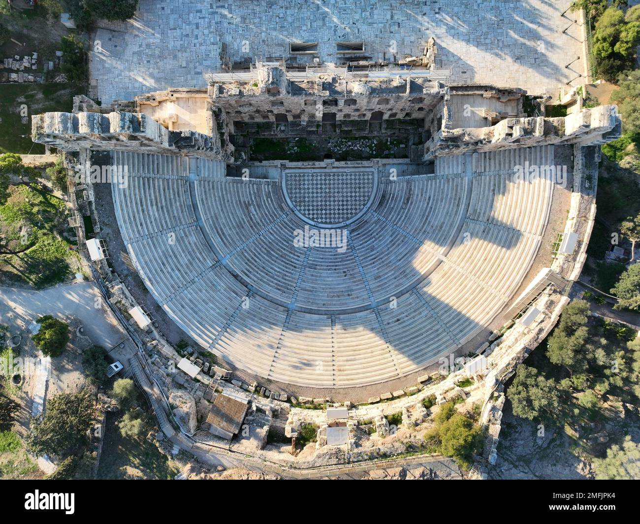 An aerial shot of the Odeon of Herodes Atticus stone Roman theatre structure in Athens, Greece ...