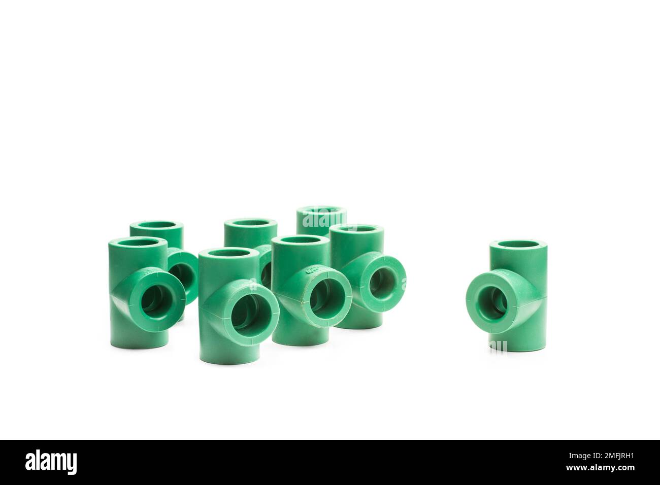Green t-shaped plastic connector for water pipe on a white background ...