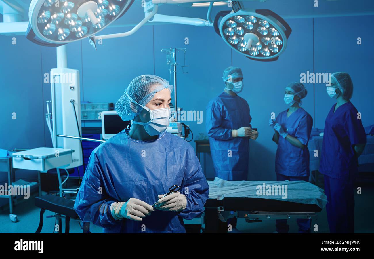 Surgeon's assistant technician standing in surgery room of hospital ...