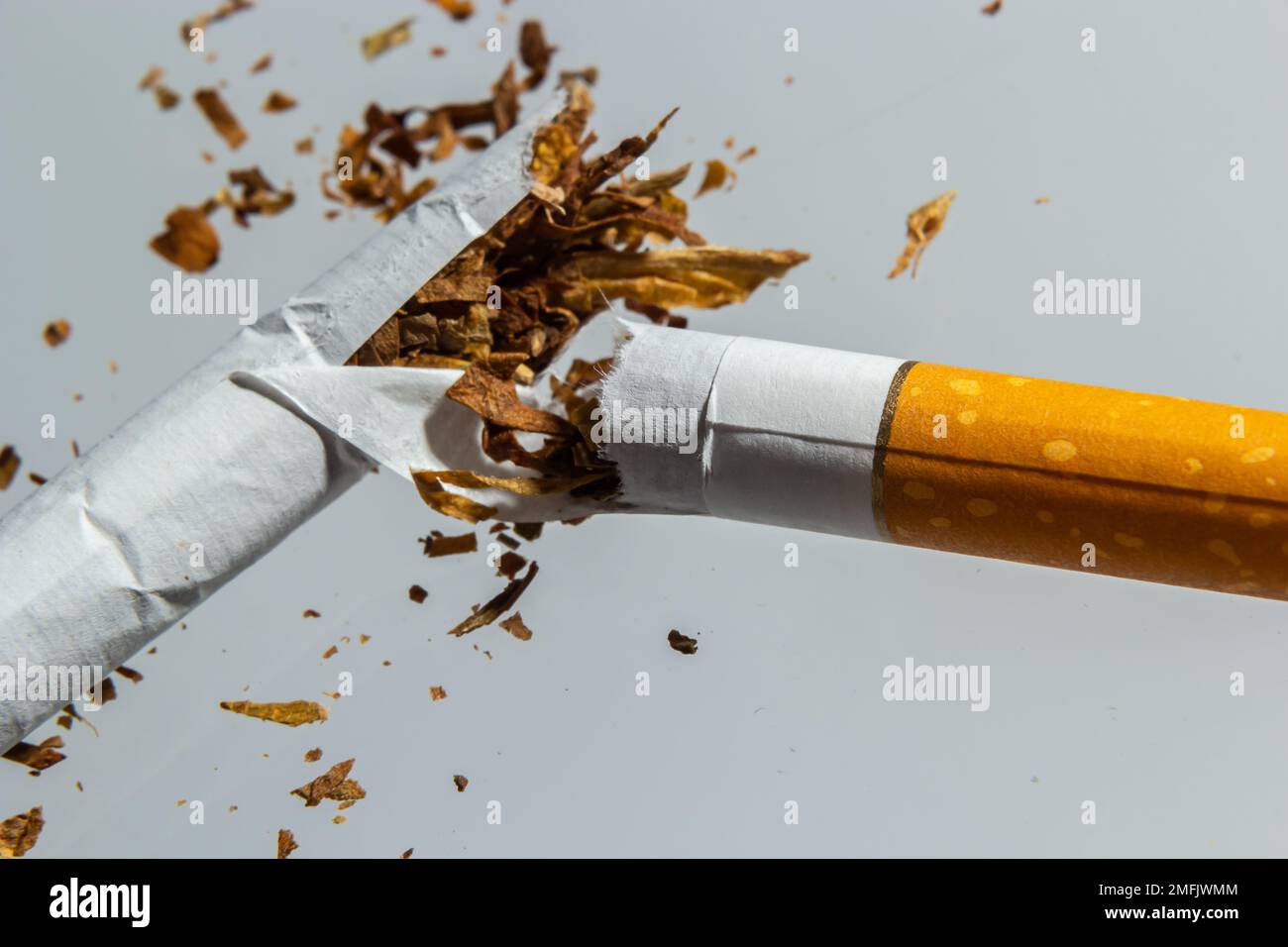 Broken cigarette fly in air on a light background. Conception of ...